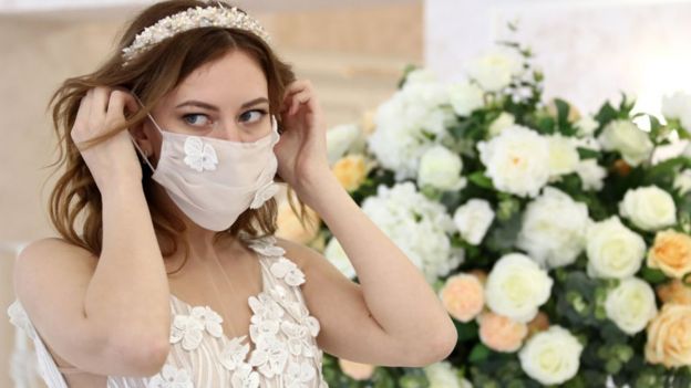 Bride wearing a mask | PreOwned Wedding Dresses